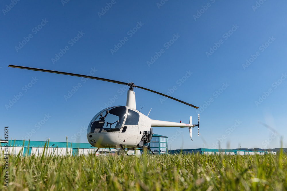 Small Robinson R22 light utility helicopter parked on grass airport ...