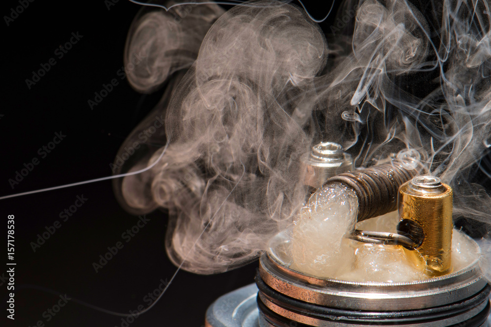 flying mod with a driptip light smoke on a black background for vaping ...
