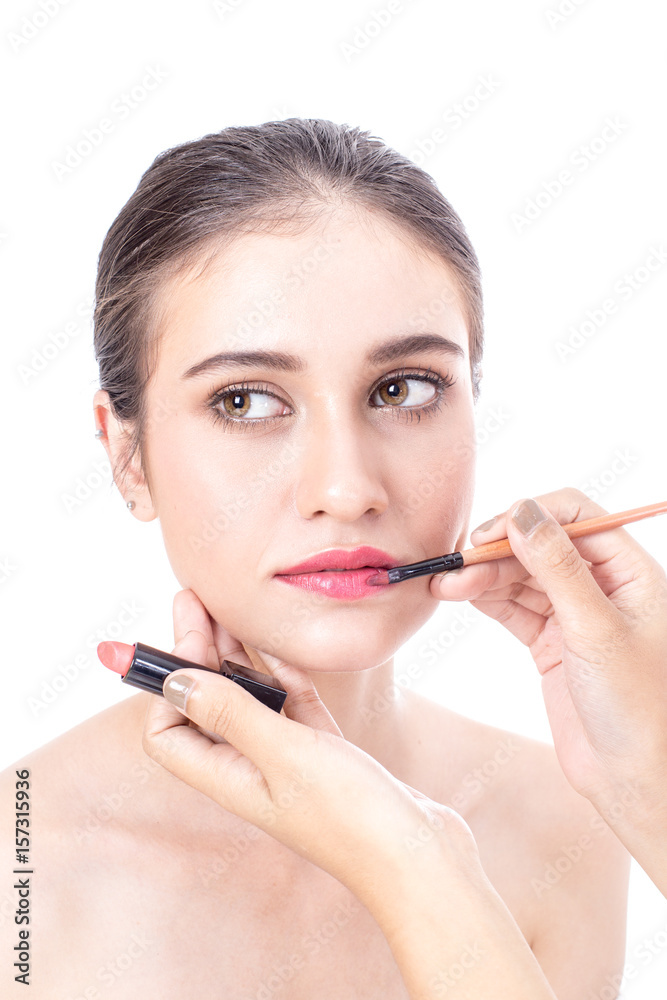 Makeup artist applies lipstick. Beautiful woman face. Perfect makeup ...