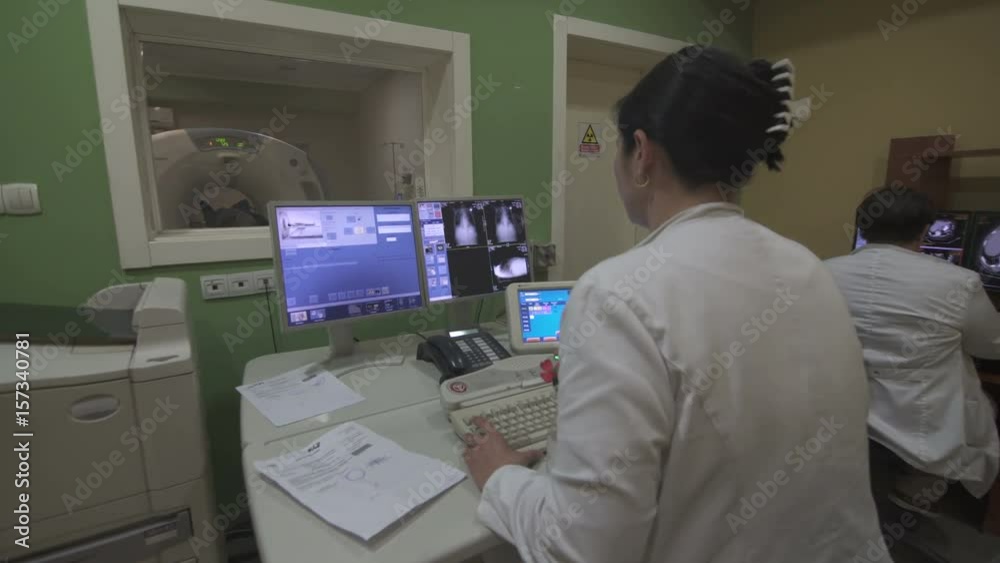 Females radiology technician and radiologist during scanning work ...
