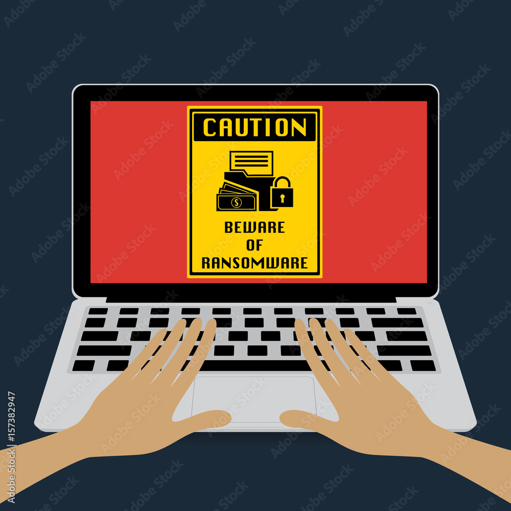 Human hands on computer laptop with beware of ransomware sign on screen ...
