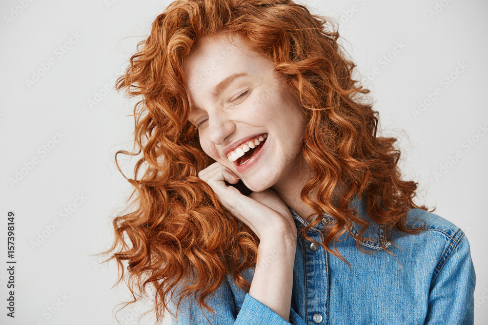 Portrait of beautiful cute ginger girl laughing smiling with closed ...
