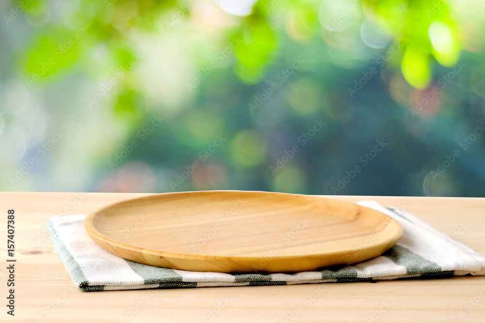 Empty wooden tray on table over blur green park background, food ...