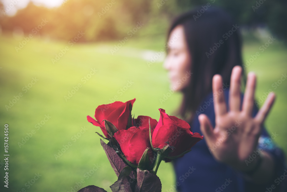 An Asian women reject a red rose flower from her boyfriend on Valentine ...