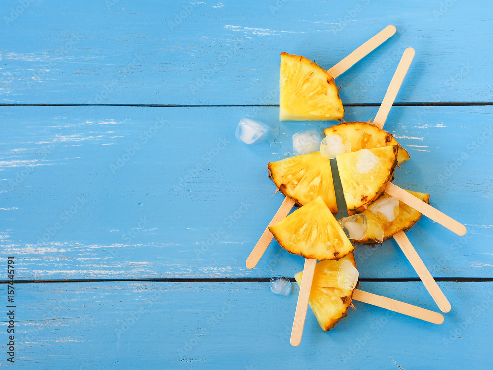 Slice pineapple popsicle sticks top view for summer fruit concept ...