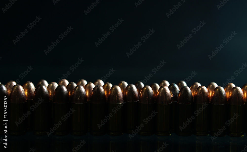 Bullets on the black mirror floor. Bullets are a projectile expelled ...