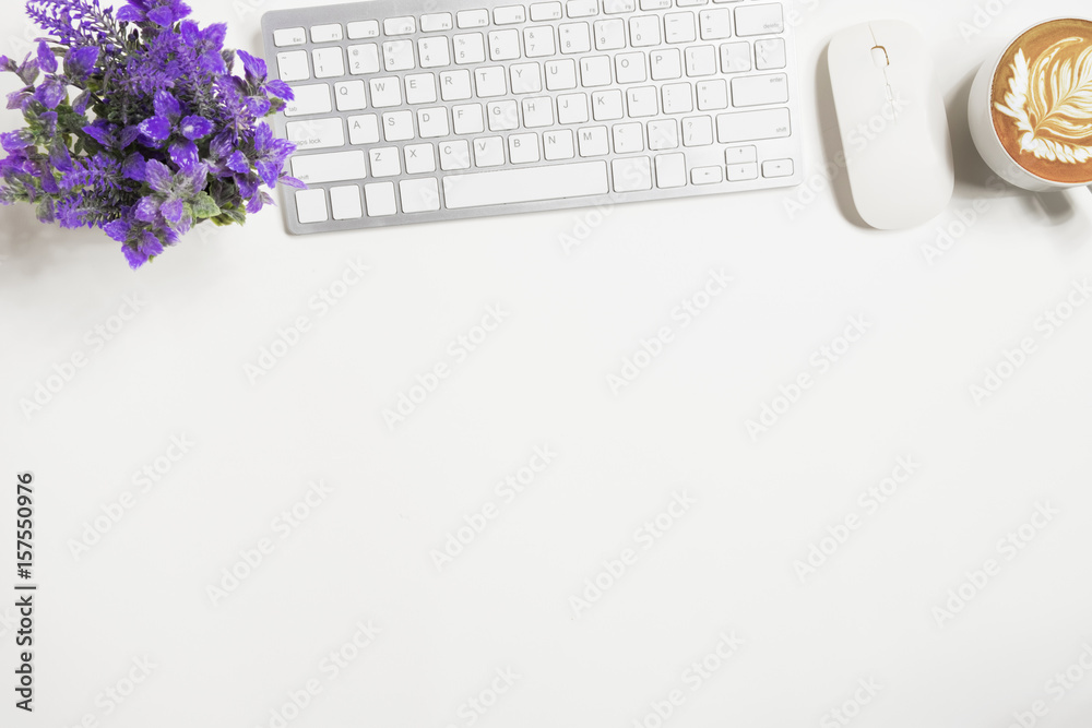 White office desk table with computer keyboard, mouse, and cup of ...