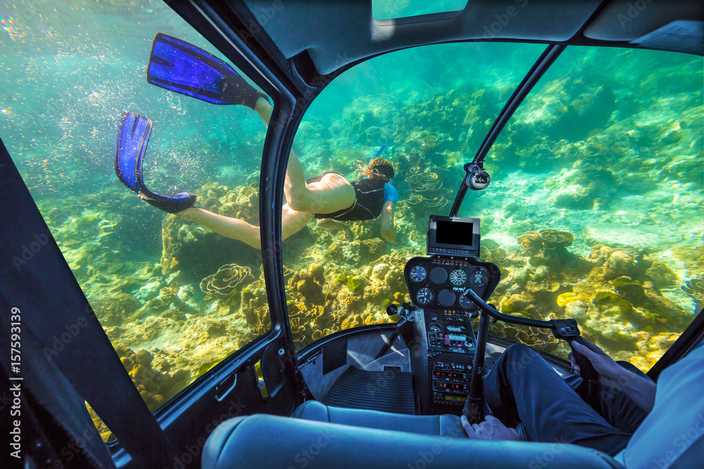 Underwater submarine ship following a woman in apnea swimming in ...