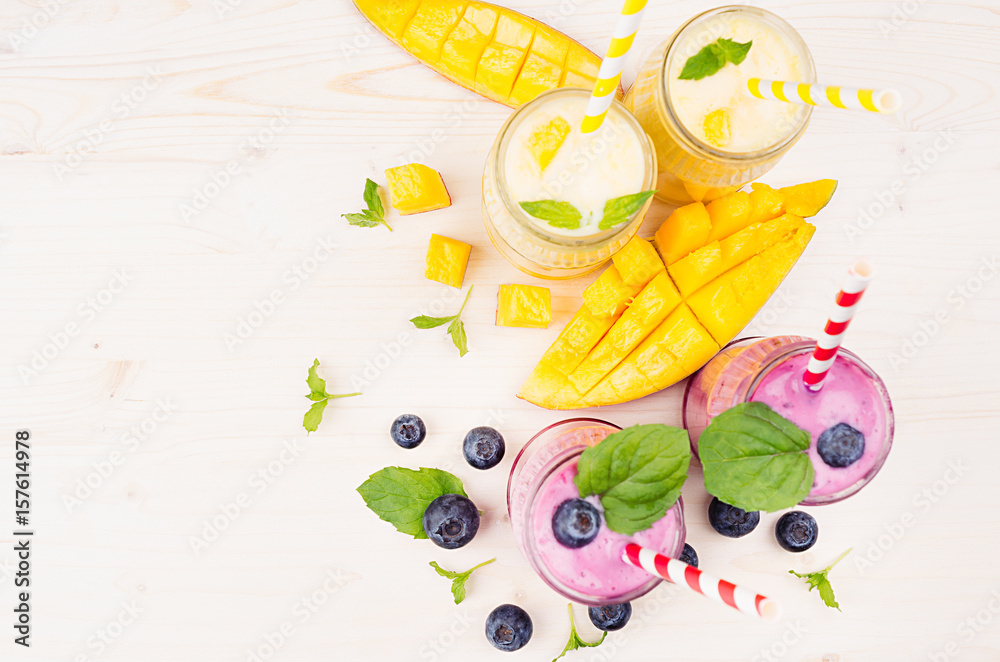 Decorative border of yellow and violet fruit smoothie in glass jars ...
