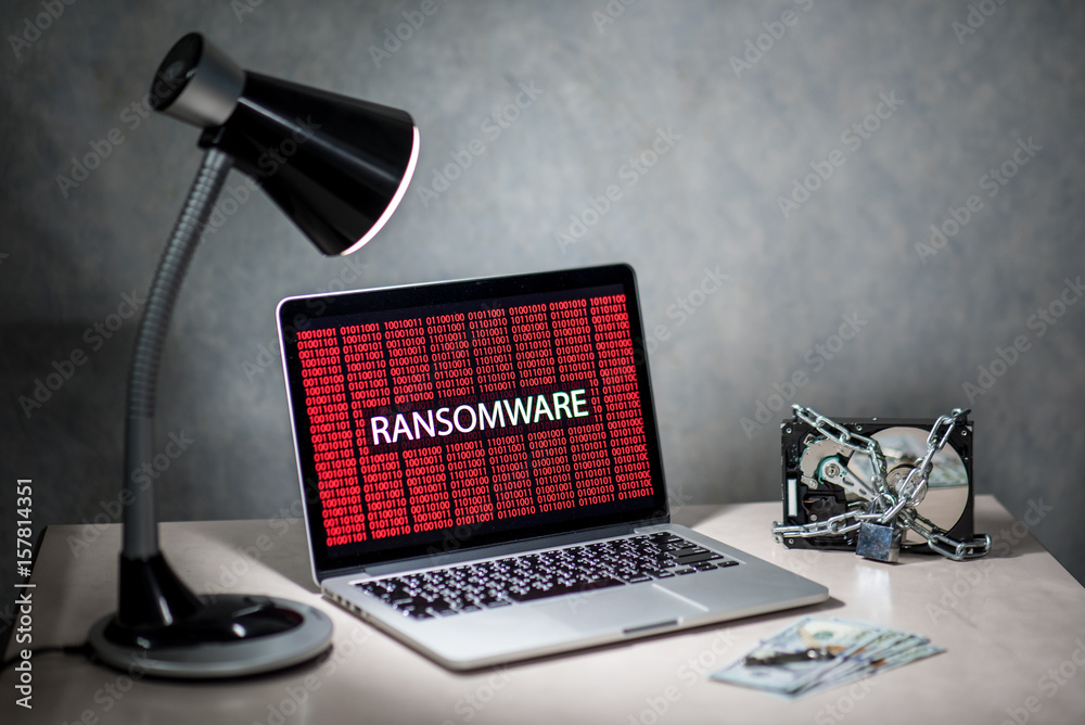 laptop computer screen with ransomware attack alert in red digital ...