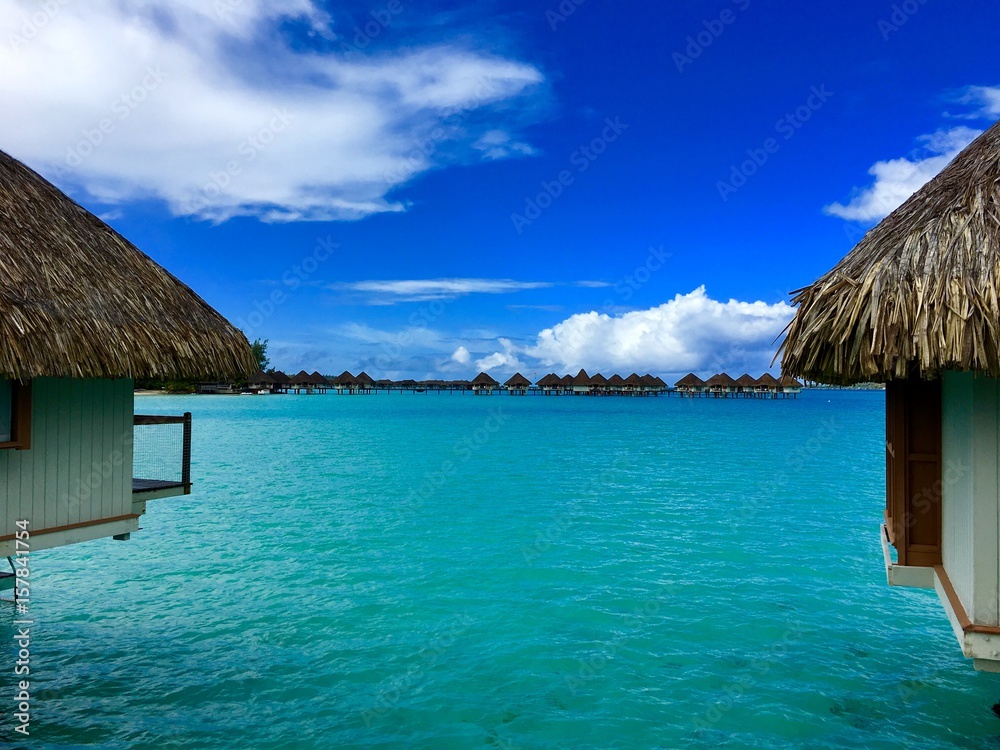 Beautiful turquoise lagoon of Bora Bora and the overwater bungalows of ...