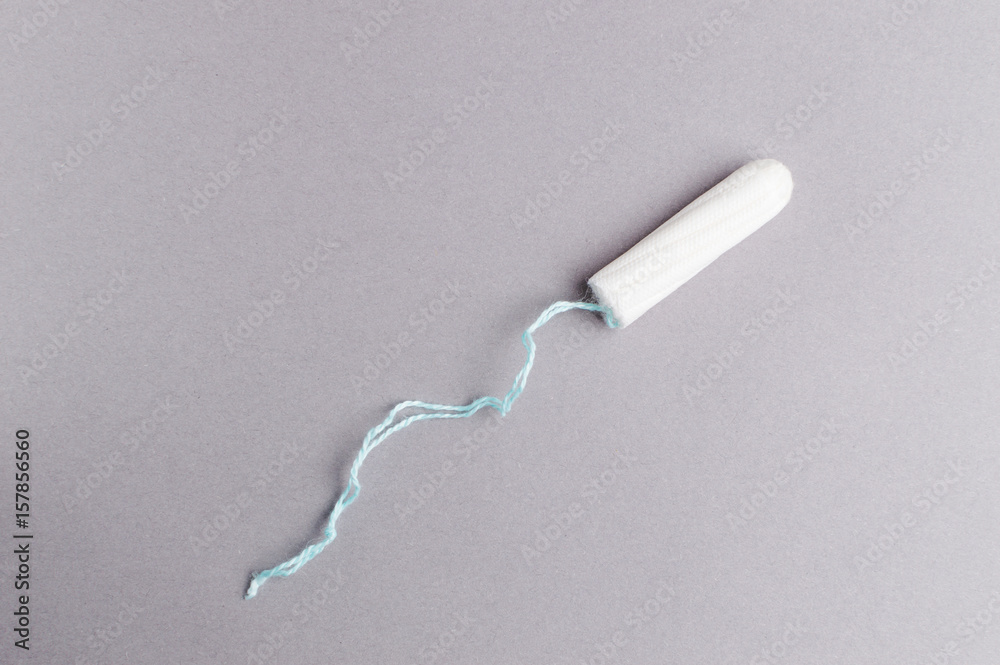Menstrual tampon on a grey background. Menstruation time. Hygiene and ...