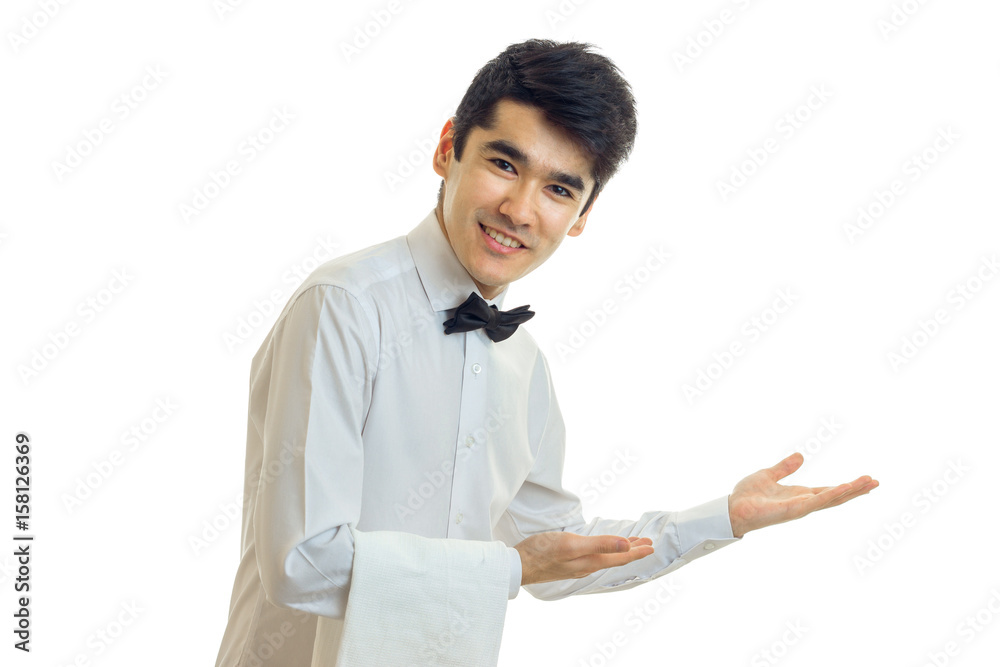 fascinating young waiter with black hair invites guests to the table ...