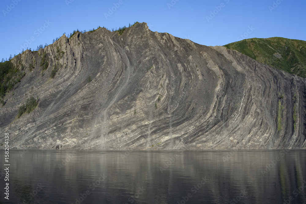 The outcrop of rocks in the river. The shown folding and tectonics. The ...