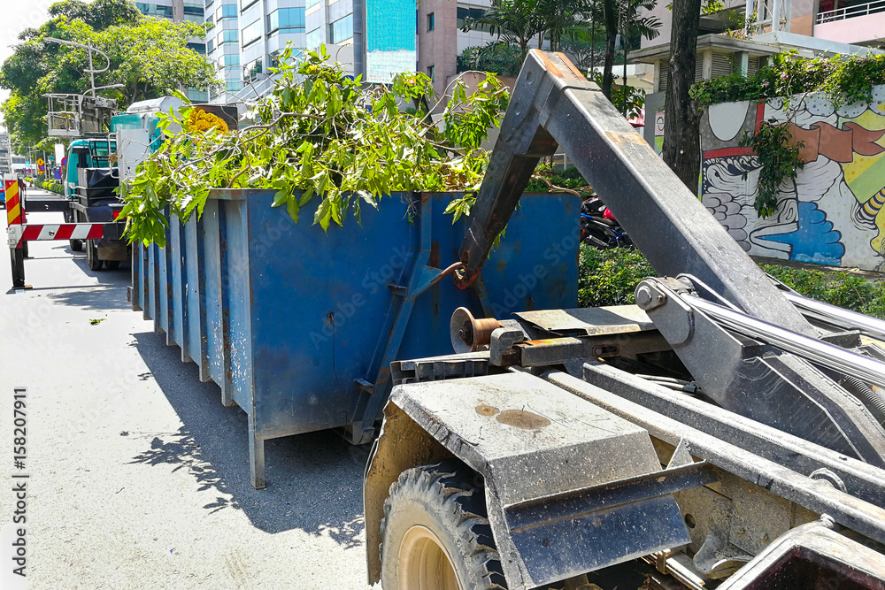 Garbage container latch with truck full of garden refuse woods Stock ...