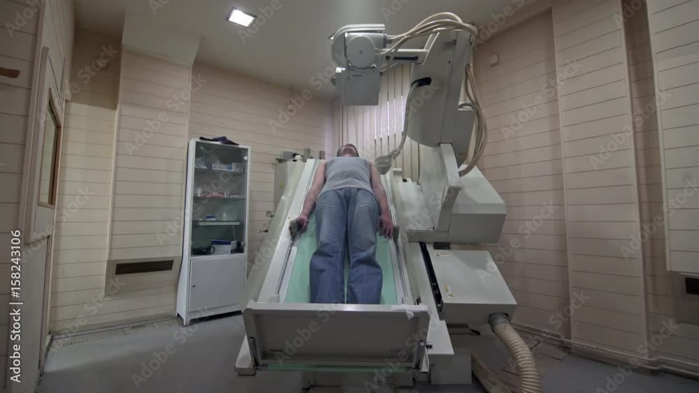 Middle aged male radiologist using scanner to performs x-ray imaging on ...