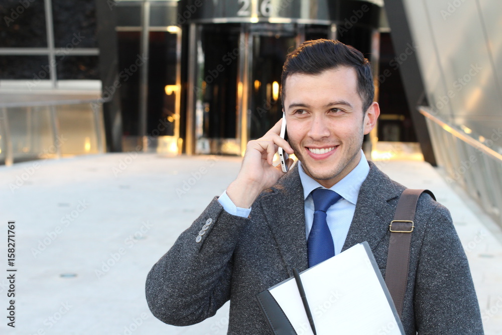 Classically good looking male isolated in office space calling by phone ...