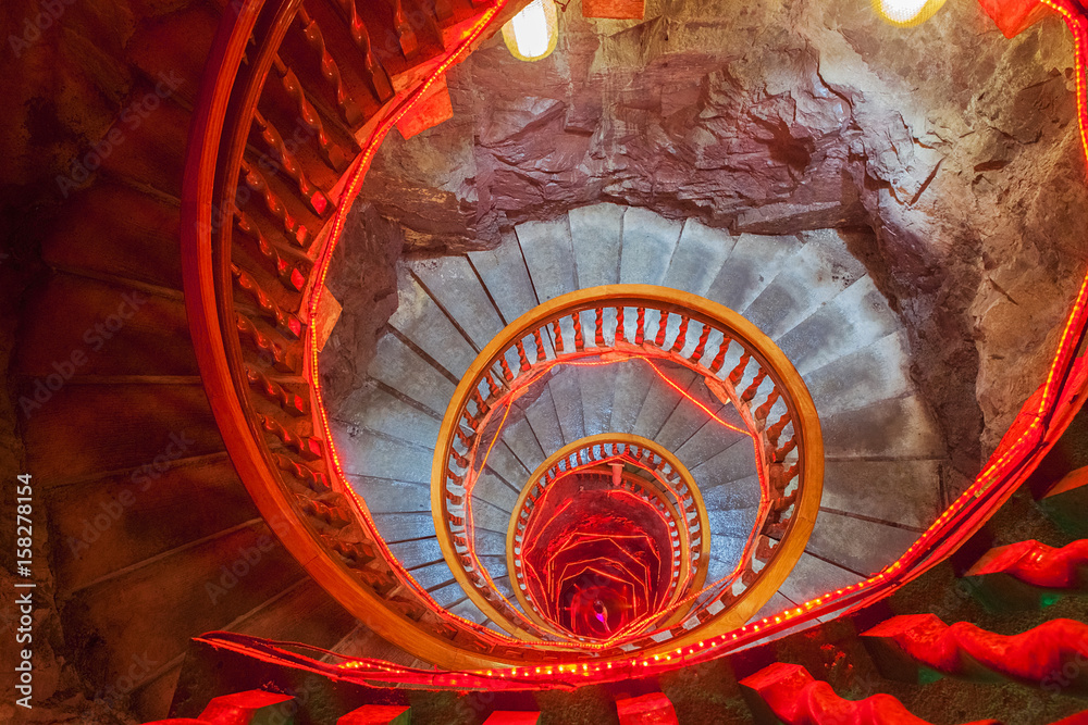 Spiral stone stairs with red painted balustrade Stock Photo | Adobe Stock