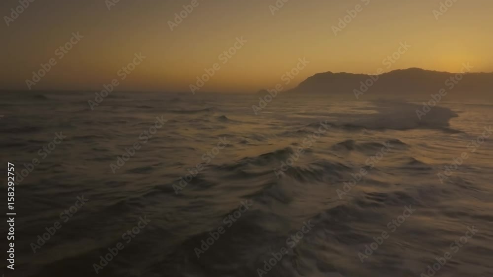 Overhead aerial reveal of a romantic beach scene at sunset. Stock Video ...