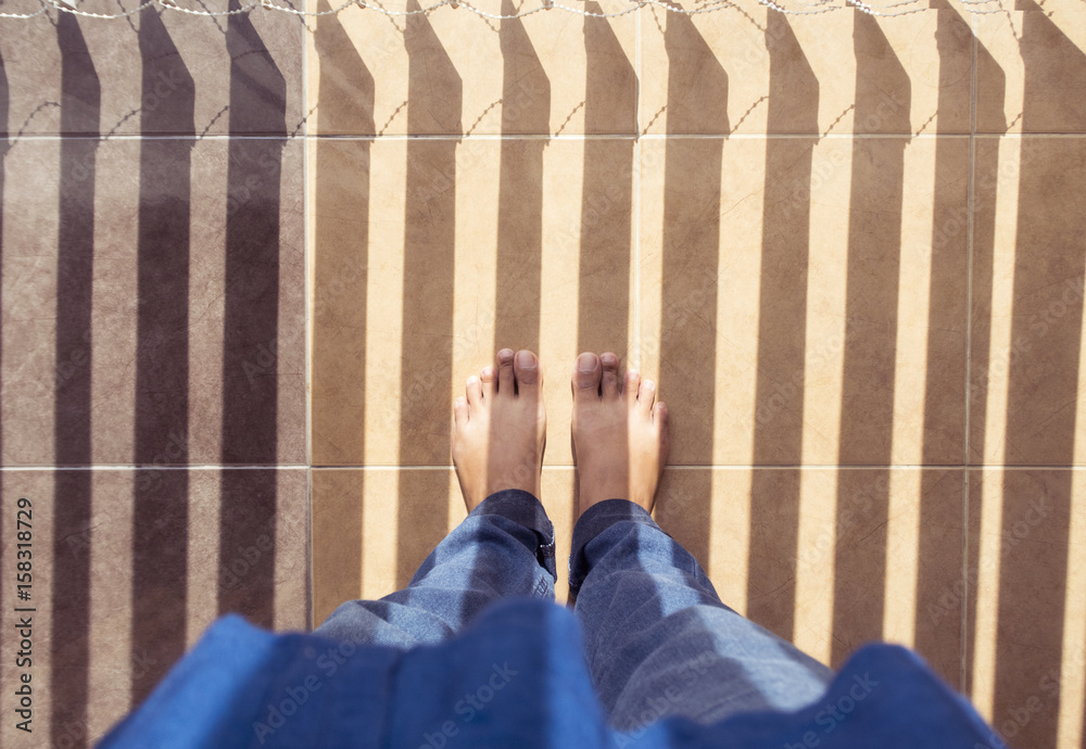 Blind shadow with woman feet on ceramic piles floor. Stock Photo ...