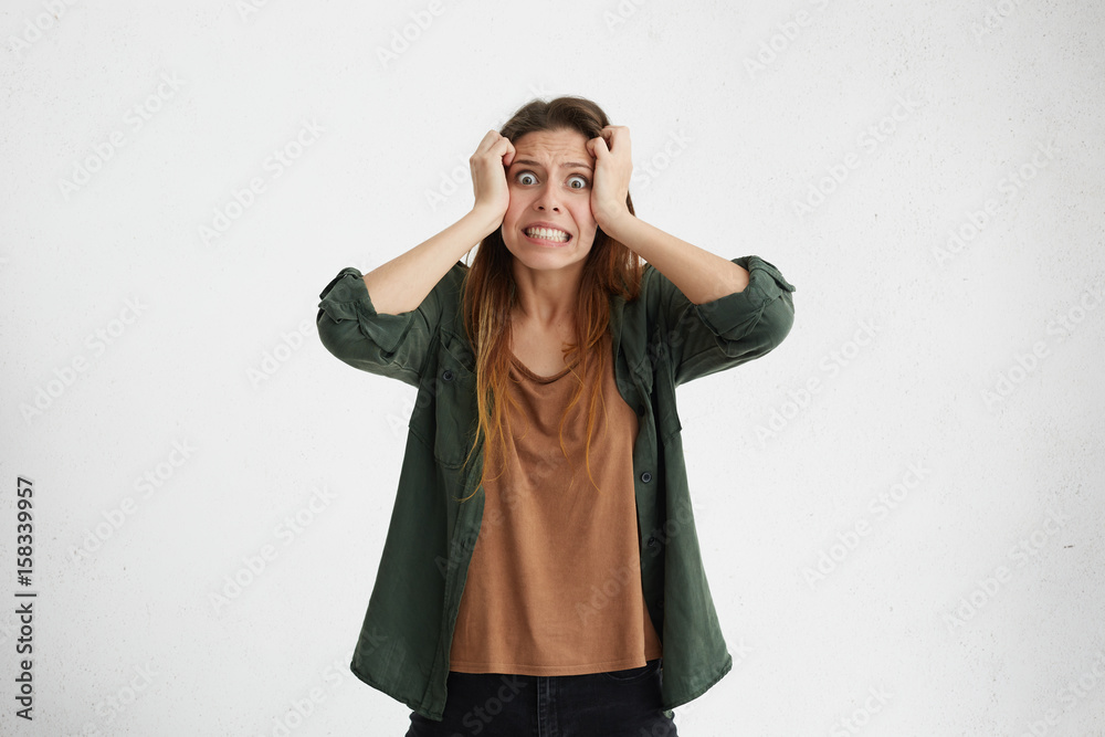 Stressed anxious young casually dressed woman tearing hair out feeling ...