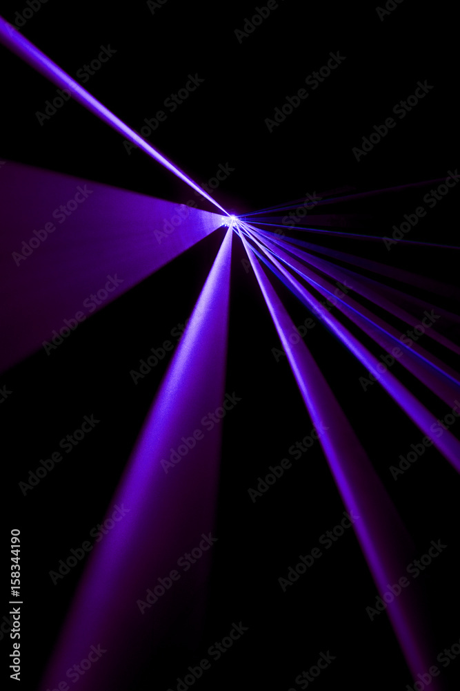 Laser beam purple on a black background Stock Photo | Adobe Stock