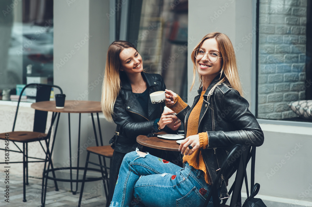Group of european girls having a coffee together. Two women at cafe ...
