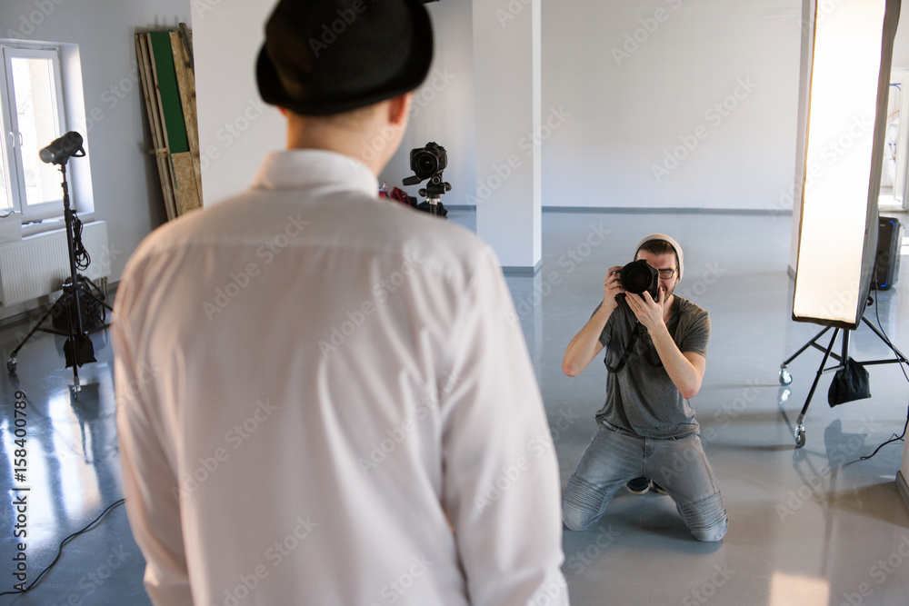 Back view of a male model posing for professional photographer in ...