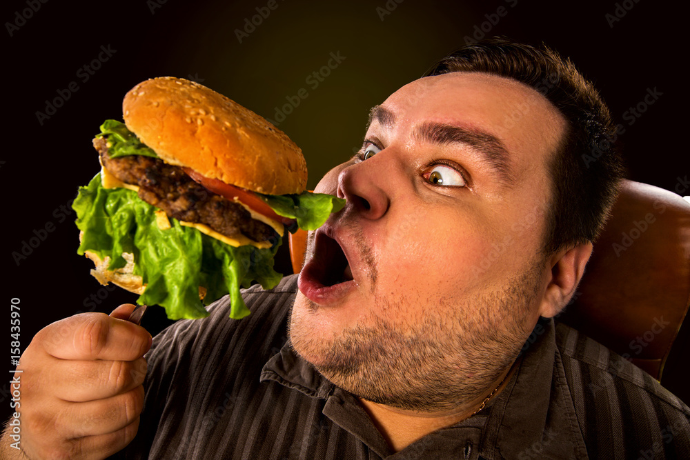 Diet failure of fat man eating fast food . Happy smile overweight ...