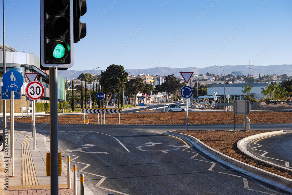 Roundabout with road markings, traffic lights and road signs. Urban ...