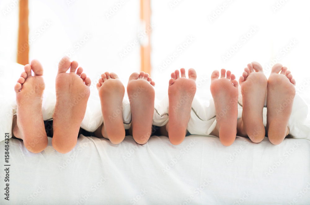 Feet of family in bed Stock Photo | Adobe Stock