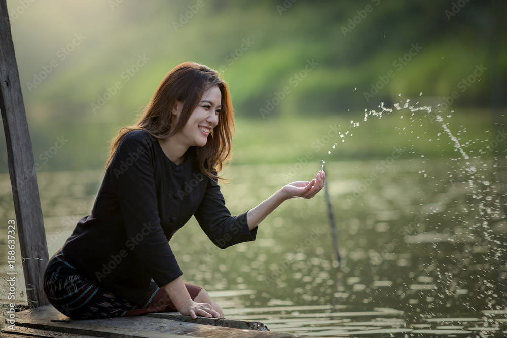 Beautiful woman joyful playing water splash in the river. Lifestyle ...