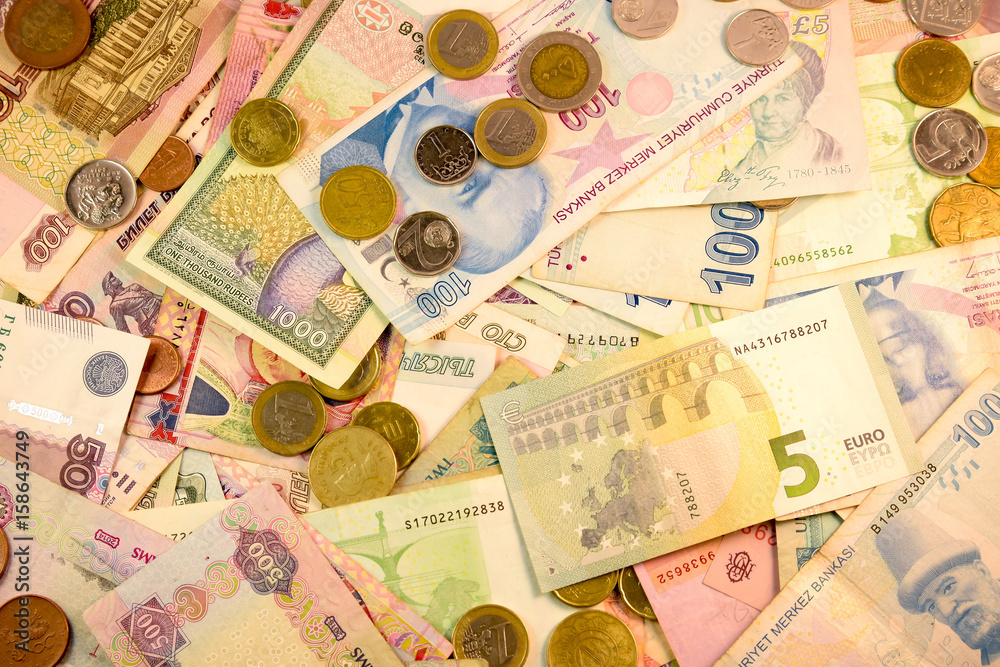 Different currency note and coins from different countries background ...