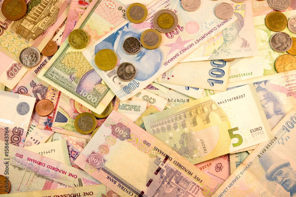 Different currency note and coins from different countries background ...