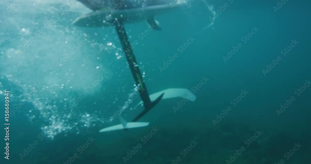 Surfer on hydrofoil surfboard riding blue ocean wave. Futuristic ...