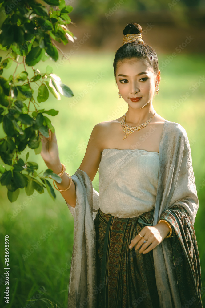 Beautiful Thai girl in Thai traditional costume Stock Photo | Adobe Stock