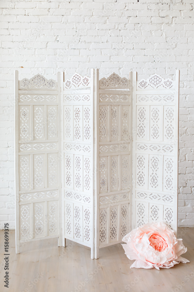 White delicate decorative wood panel with big paper flowers on white ...