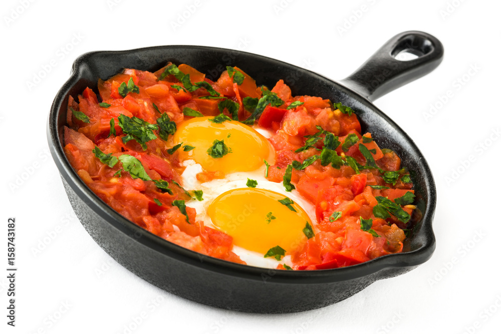 Shakshuka in iron frying pan isolated on white background. Typical food ...