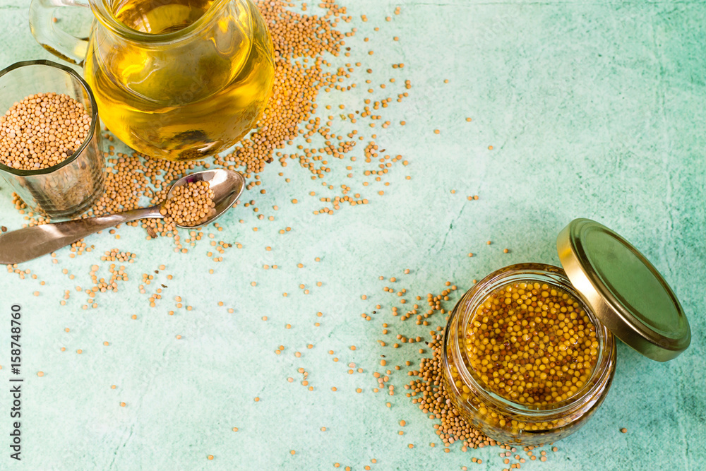Mustard. A jar with cooked mustard, a small glass with mustard seeds ...