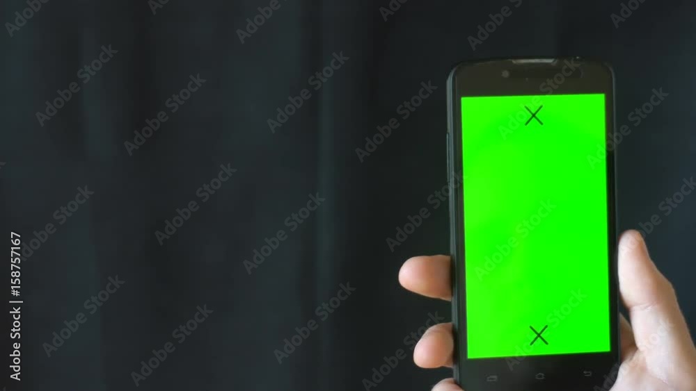 Close-up of male hands touching of smartphone. Green screen Chroma Key ...