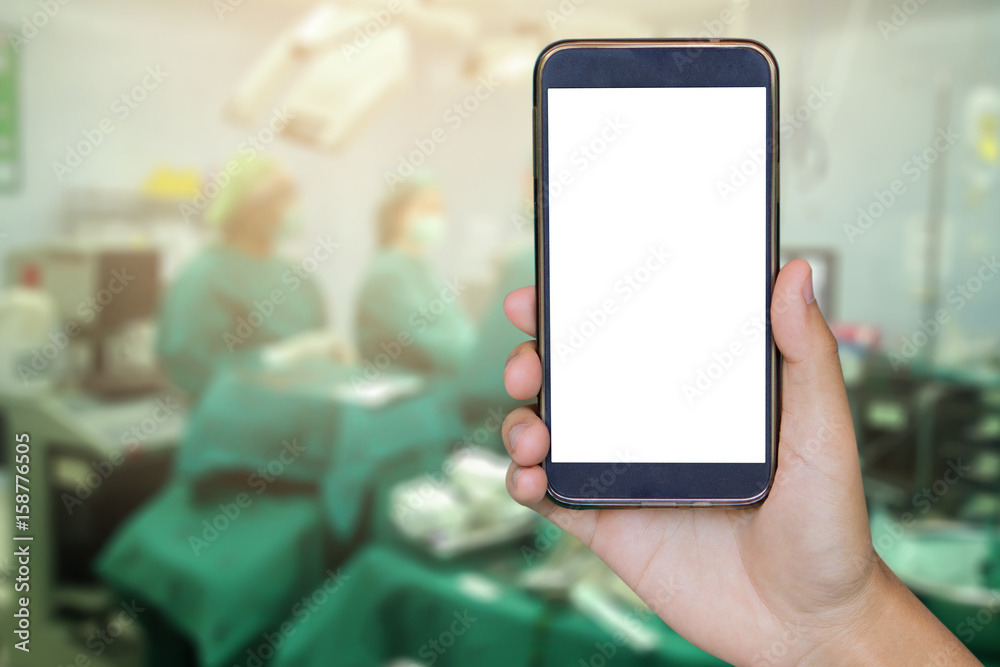 Man hand holding mobile smart phone , tablet,cellphone over Blur of ...