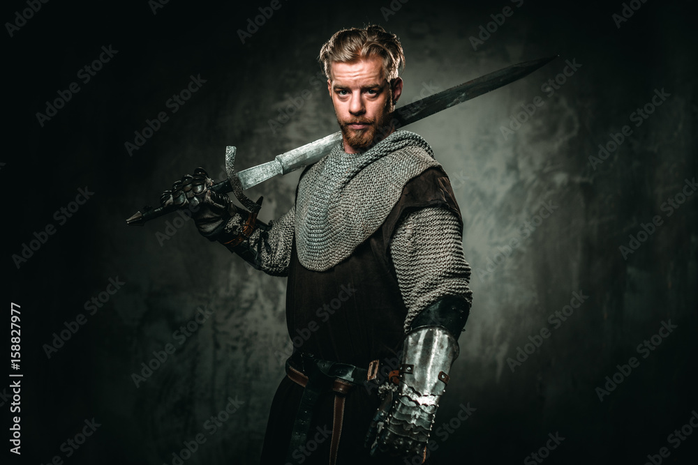 Medieval knight with sword and armour Stock Photo | Adobe Stock