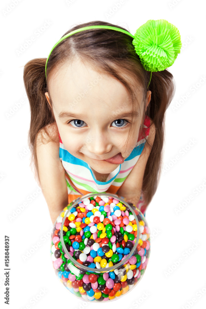 Funny child with candys licking her lips on a white background. Happy ...