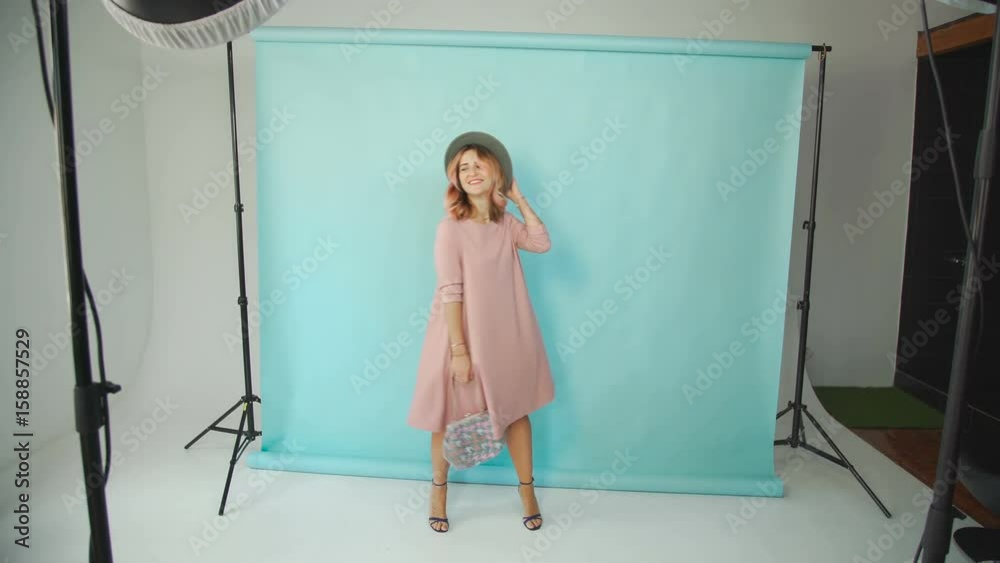 Professional photo studio: a girl model poses against the background of ...