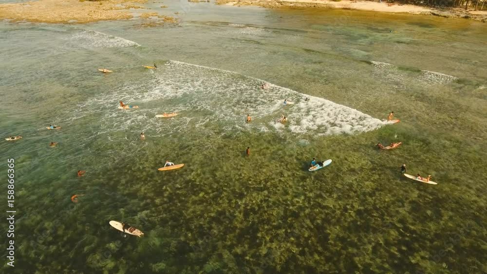 Surfers at siargao islands famous surf break cloud 9 near mindanao the ...