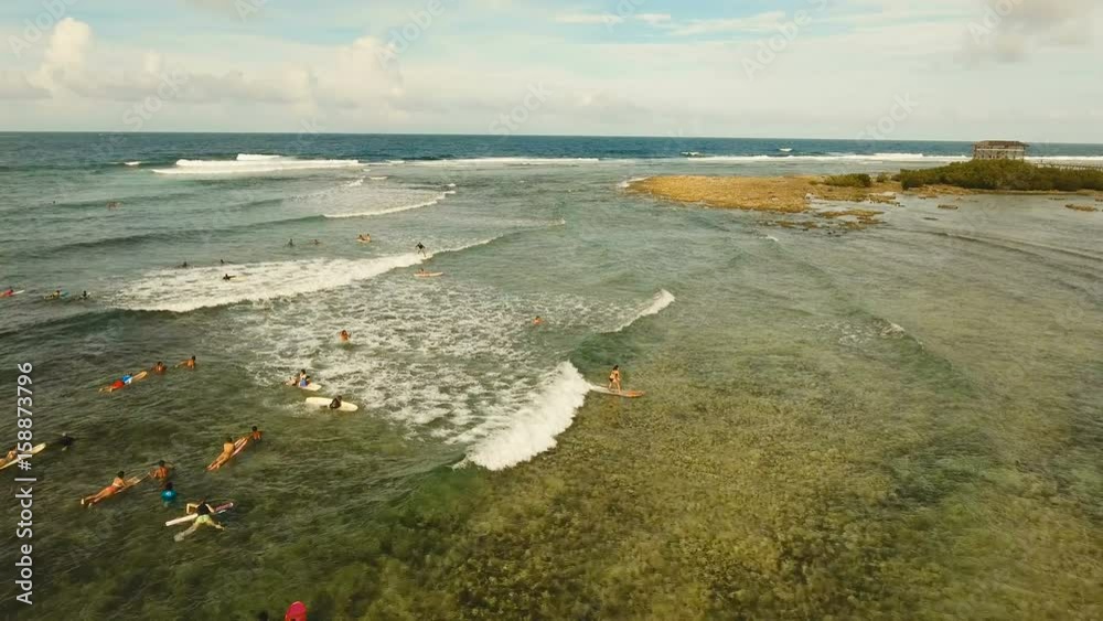 Surfers at siargao islands famous surf break cloud 9 near mindanao the ...