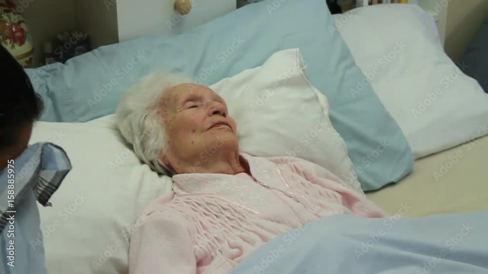 Elderly woman dies in bed, family cries Stock Video | Adobe Stock