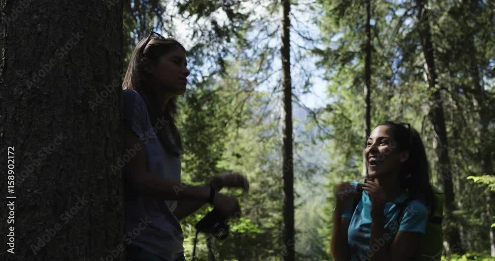 Woman playing joke scaring friend photographer in sunny forest woods ...