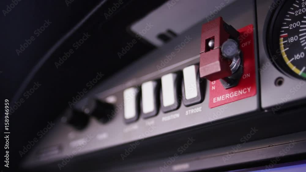 Plane control panel. Switches on plane cockpit. Close up of red ...