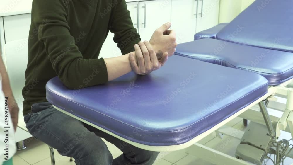 Young patient with hand injury sitting in department of traumatology ...